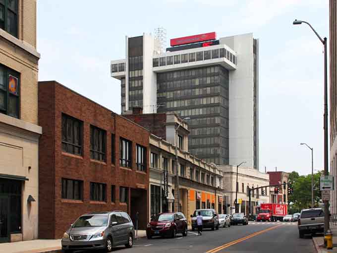 Older brick buildings stand shoulder-to-shoulder with modern towers, creating an honest cityscape that doesn't apologize for its working roots.