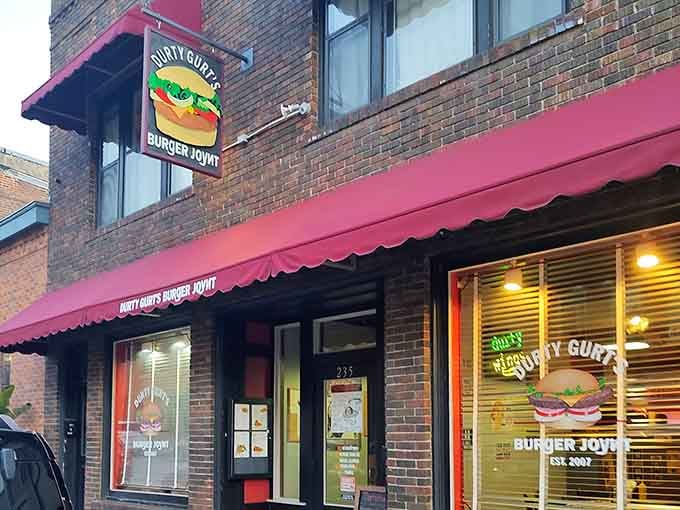 That cheerful pink awning and playful burger sign promise no-nonsense comfort food in a town built for relaxation.