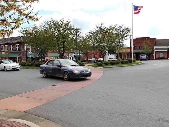 The town circle's brick crosswalk guides visitors like a red carpet, with that American flag waving proudly overhead.