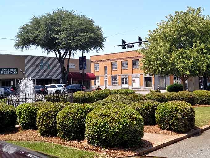 Perfectly manicured round bushes frame the town square like green sculptures guarding a peaceful gathering place.