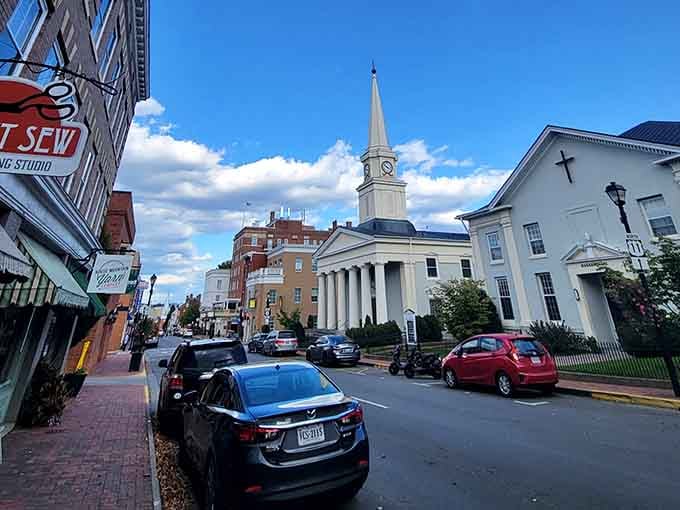 Church steeples pierce blue skies while local shops line the sidewalks, creating communities where people still know their neighbors' names.