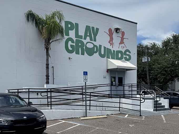 Palm trees frame the entrance to this unassuming building, hiding the colorful chaos of fun waiting inside.