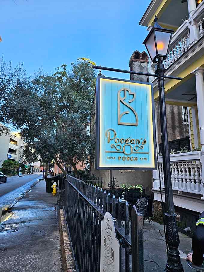 The elegant turquoise sign hanging beneath gas lamps whispers of Southern grace and historic Charleston dining traditions since 1976.