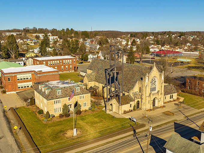 That stone church tower rises above the rooftops like a beacon, anchoring the community with solid, enduring presence.