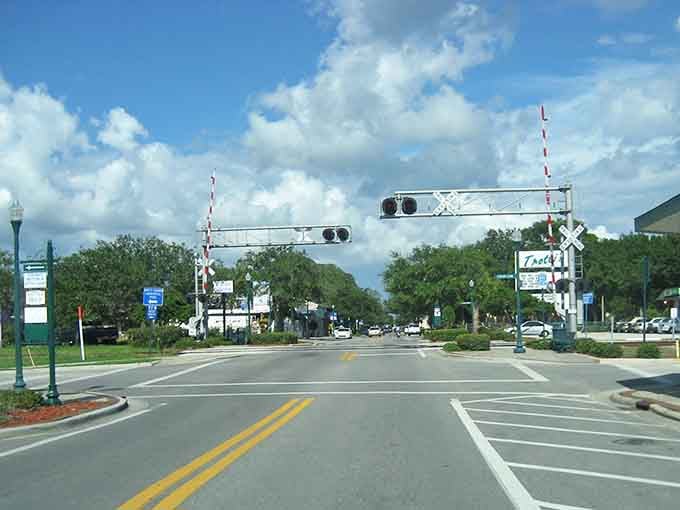 Safety Harbor's railroad crossing signals stand like sentinels, guarding a town where time moves at its own leisurely pace.