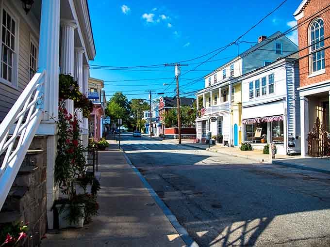 Morning light stretches long shadows across empty streets that will soon bustle with neighbors greeting neighbors by name.