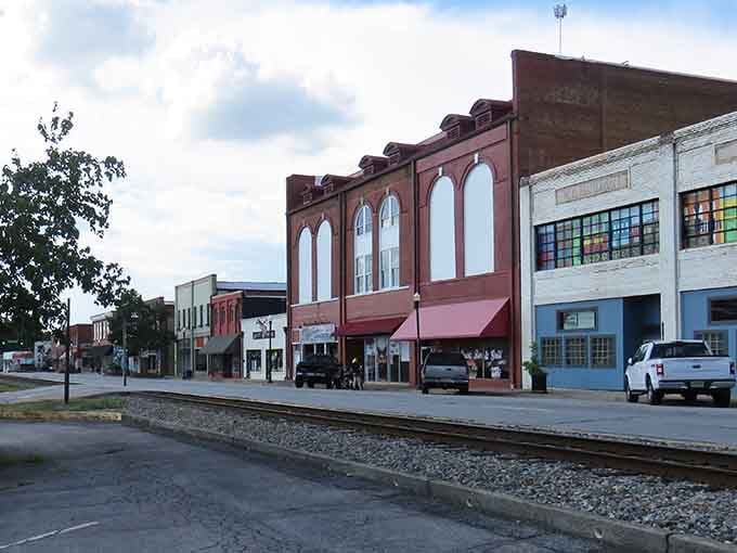 Historic buildings along the tracks stand ready for their close-up, wearing their vintage charm like a well-loved Sunday suit.