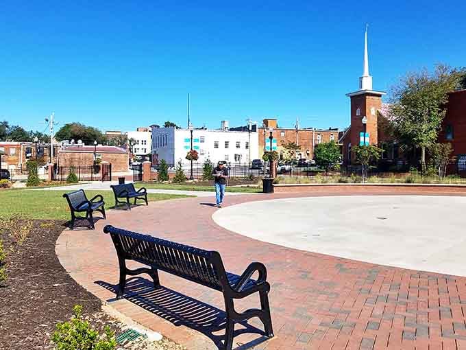 That brick plaza and church steeple create a town center where community still means something real and tangible.