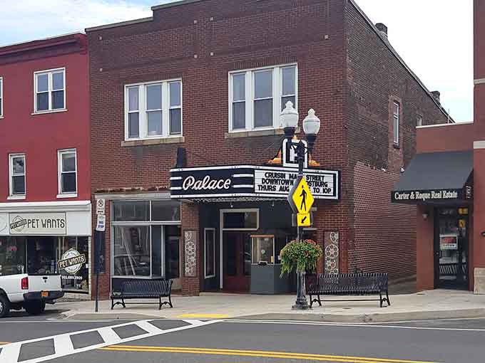 The Palace Theatre marquee glows with promise, offering small-town entertainment where popcorn costs what it should.