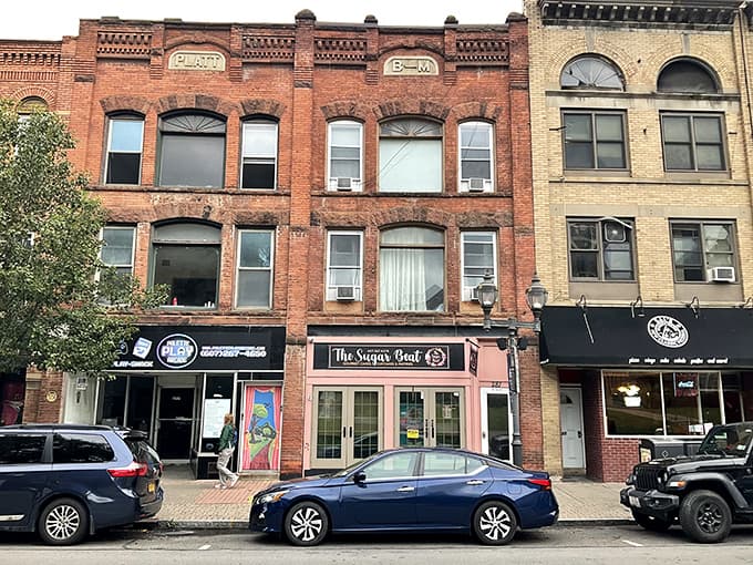 Mixed architectural styles stand shoulder to shoulder along this main street where every storefront has its own story.