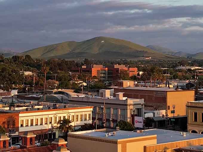 Sunset turns downtown buildings into glowing amber blocks, with those rounded hills providing a dramatic backdrop for evening strolls.