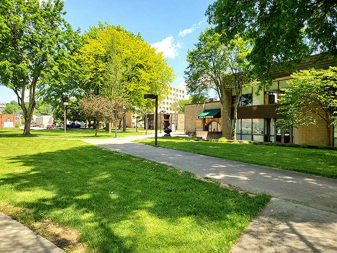 Green lawns stretch invitingly under shade trees, offering the perfect spot to rest and watch small-town life unfold.