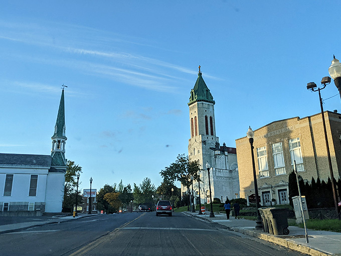 Church steeples pierce the sky while tree-lined streets remind you that some towns still know how to balance faith and nature.