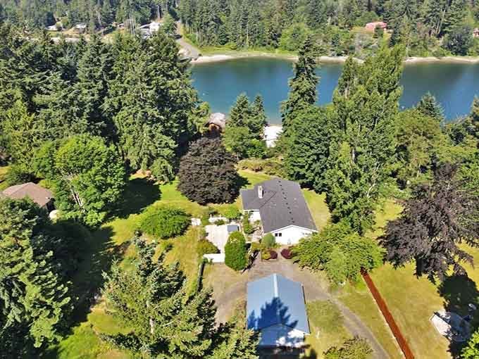 Manicured lawns meet waterfront property in a bird's-eye view that real estate agents dream about at night.