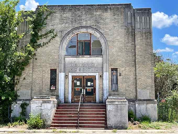 Dramatic clouds swirl above the empty building, where peeling paint and period details tell stories of community history.