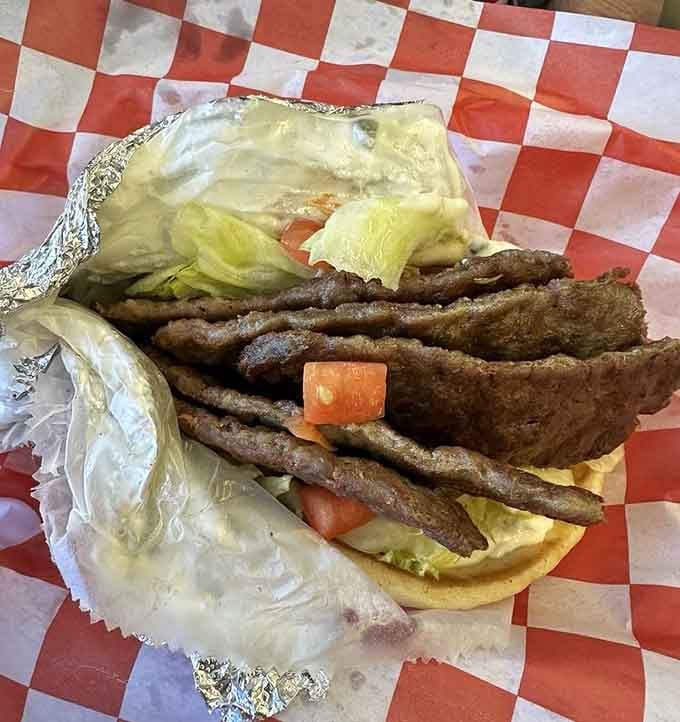 Layers of seasoned gyro meat tumble from pita bread like a delicious avalanche you'll want to get buried under.