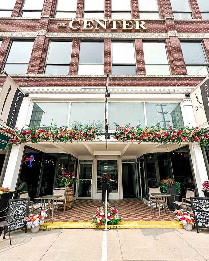 The Center Building's flower-adorned entrance welcomes visitors to downtown shops where owners remember your name, not your data.