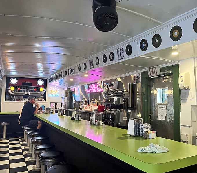 That long counter with chrome stools and vintage records above creates the ultimate solo dining experience for people-watching.