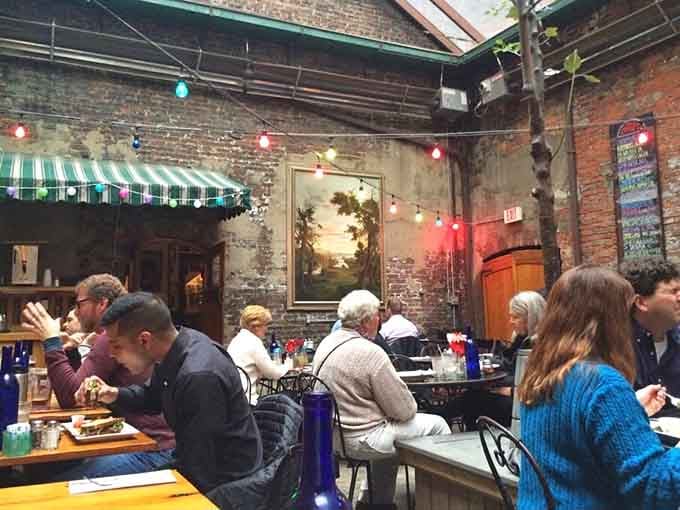 The courtyard transforms this historic tavern into an open-air gathering spot where community happens naturally every day.