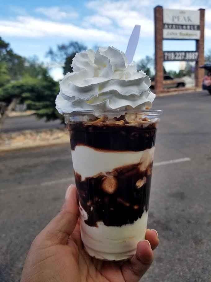 Layers of hot fudge and vanilla ice cream creating a sundae that's basically edible architecture at its finest.