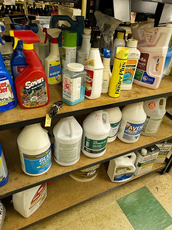 Household cleaners lined up like soldiers, proving even the mundane stuff finds a home in this treasure trove.