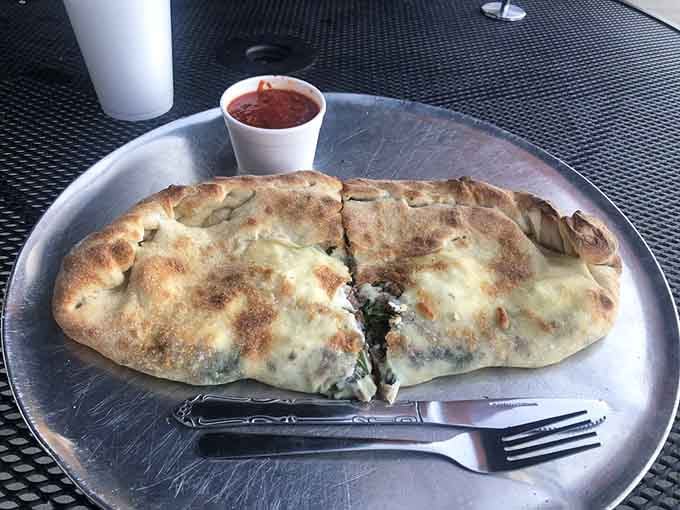 Golden calzones arrive like little pillows of joy, ready to deliver cheesy dreams with every bite.