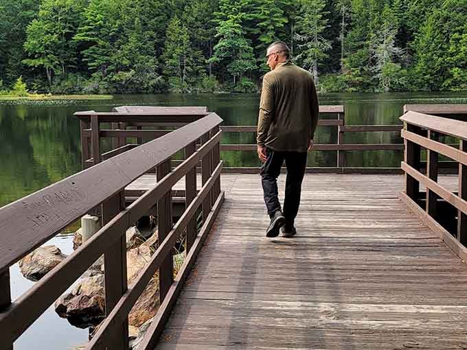 A wooden dock stretching into stillness, where contemplation comes standard and stress checks out early.