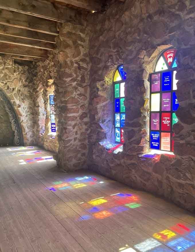 Stained glass transforms sunlight into rainbow puddles on the floor, nature's own disco ball effect without electricity.