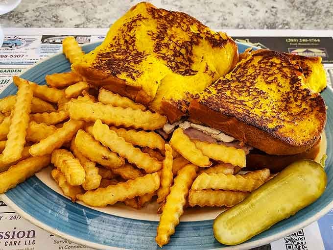 Monte Cristo sandwich achieving that perfect golden crust while the crinkle fries provide essential structural support and crunch.