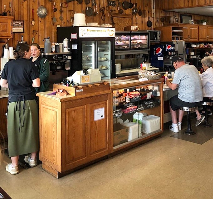The counter where locals gather, coffee flows freely, and the pie case tempts you from every possible angle.
