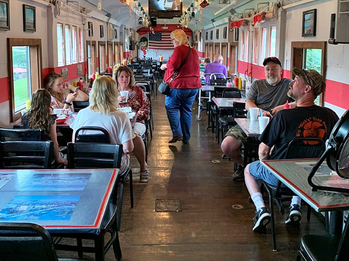 Families filling the booths, conversations flowing, and everyone looking genuinely happy to be eating in a train.