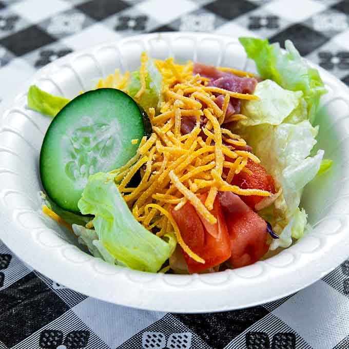Fresh salad with all the fixings, because even at a buffet, balance is technically still a thing.