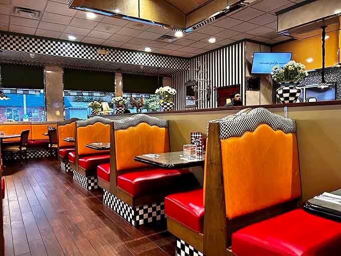 Red booths and checkerboard patterns create cozy corners where conversations flow as freely as the coffee.