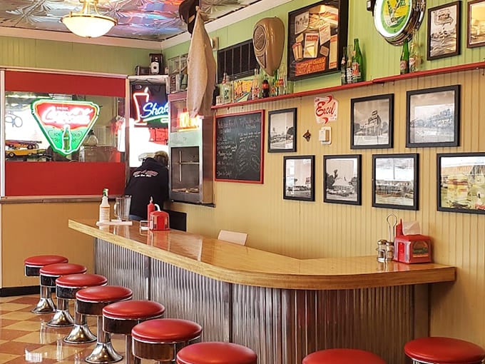 Red vinyl stools at a classic counter where conversations flow as freely as the root beer.