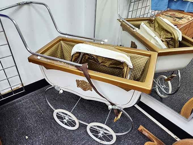 A vintage baby carriage that's either a collector's dream or the most unique planter you'll ever own, your choice.