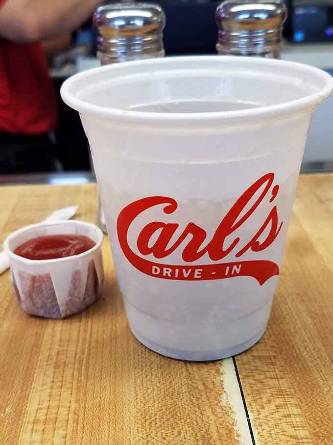 Even the disposable cups get the Carl's Drive-In treatment, because branding matters when you're serving liquid happiness.