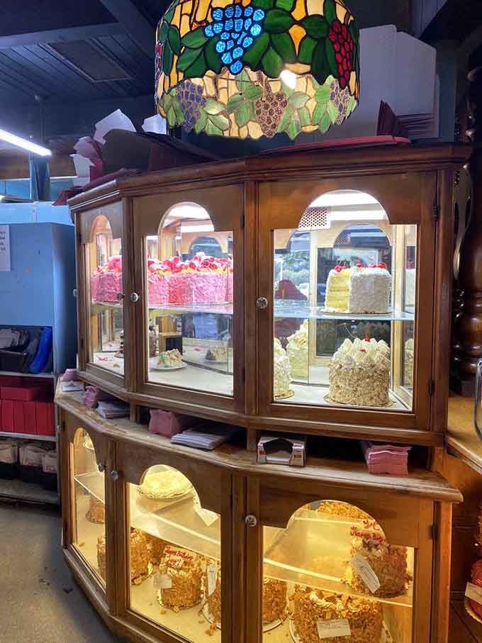 The cake display case is basically edible art, showcasing towering creations that belong in a bakery museum.