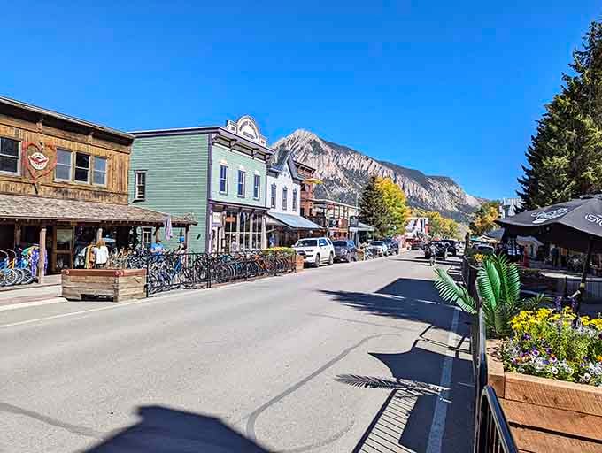 Elk Avenue stretches toward the peaks, lined with shops that actually sell things locals need, imagine that.