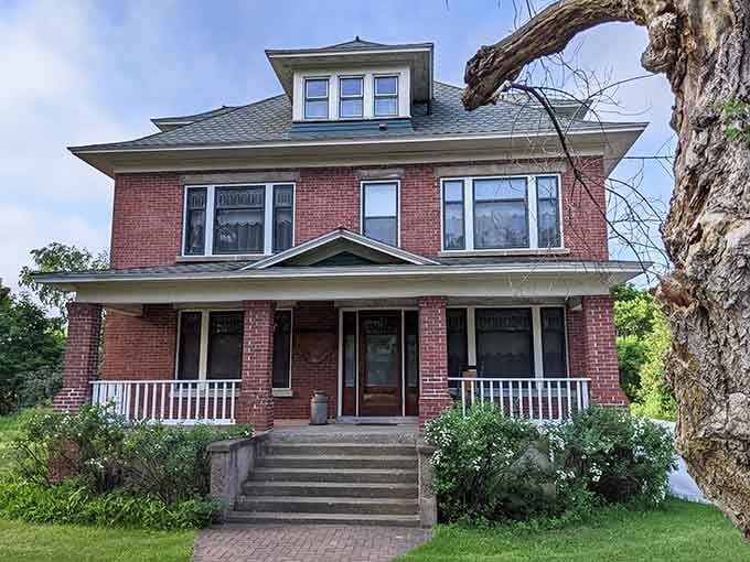 This classic American foursquare home stands as testament to when porches were for sitting, not just architectural flourishes for real estate listings.