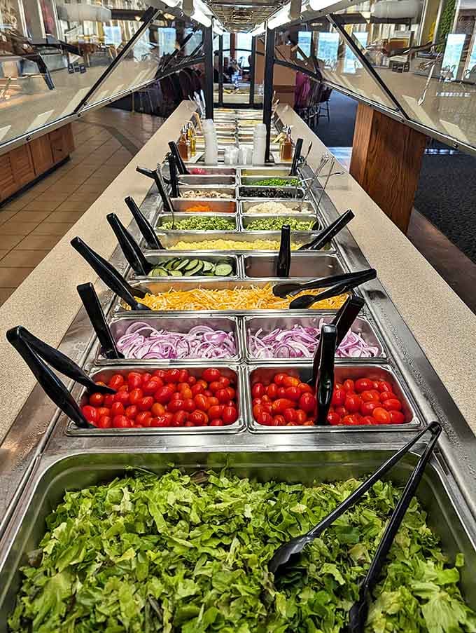 The salad bar stretches out with fresh vegetables, proving that even healthy options get the royal treatment here.