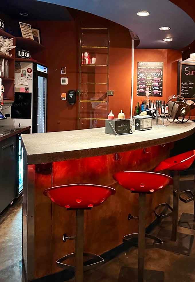 Counter seating with warm lighting creates an inviting spot to watch the burger magic happen.