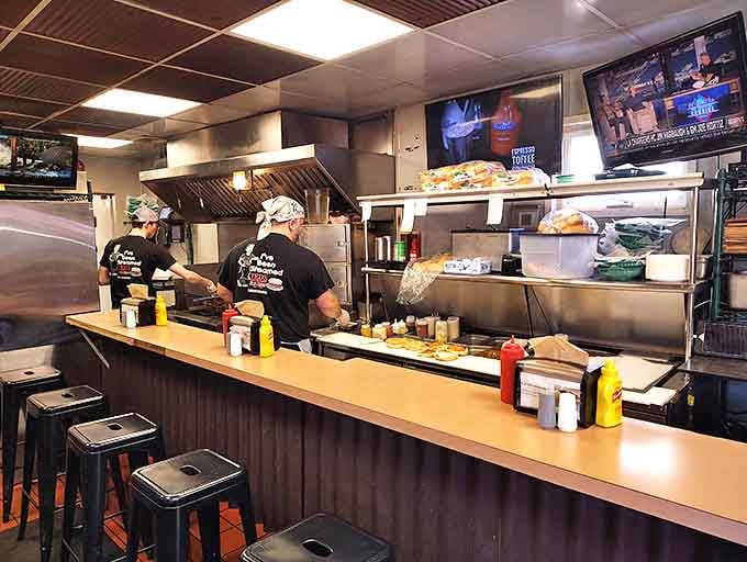 The open kitchen isn't just practical &ndash; it's dinner and a show where the choreography involves spatulas and the soundtrack is sizzling perfection.