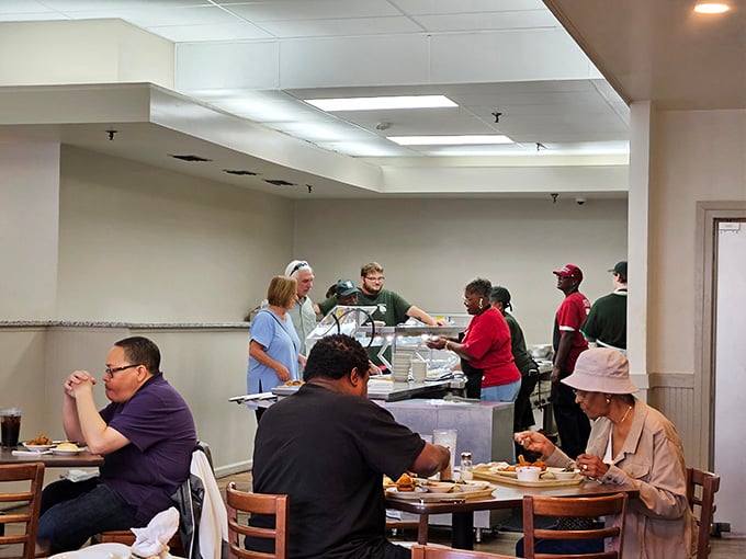 The cafeteria line in action&mdash;where strangers become comrades united in the noble pursuit of comfort food and second helpings.