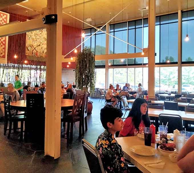 Sunlight streams through floor-to-ceiling windows, illuminating families gathering for that timeless ritual: the shared seafood feast.