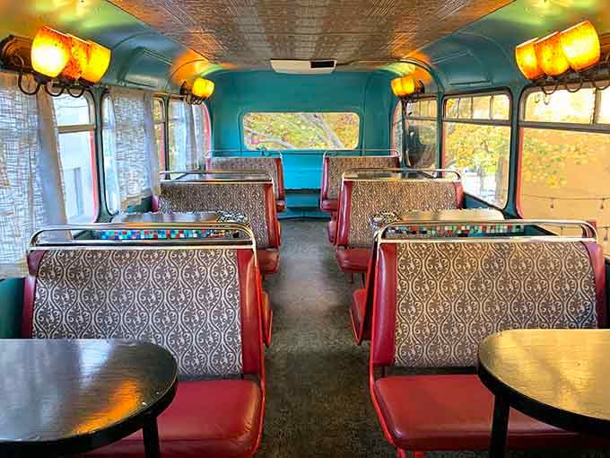 The upper deck seating area features vintage bus seats and tables, creating the coziest mobile caf&eacute; you've ever experienced.