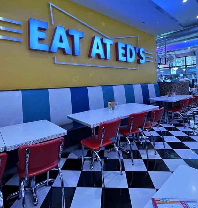 Blue and white booths lined up like soldiers ready to serve you comfort food with a side of comedy.