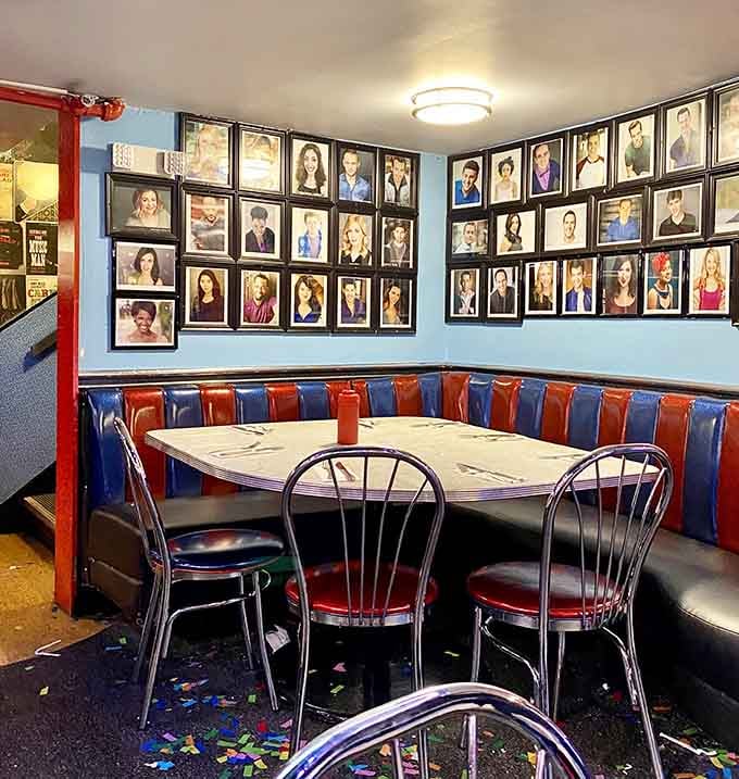 Headshots of former singing servers line the walls, a reminder that your waiter might be tomorrow's Broadway headliner.