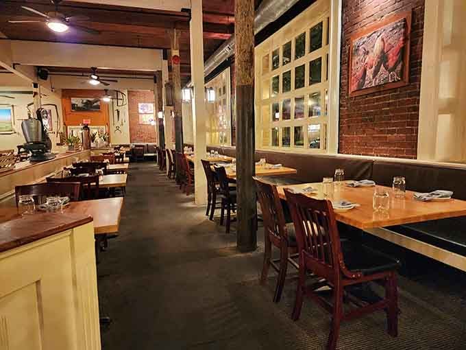 Cozy booth seating under vintage lighting where you can settle in for the long haul, because rushing great food is criminal.