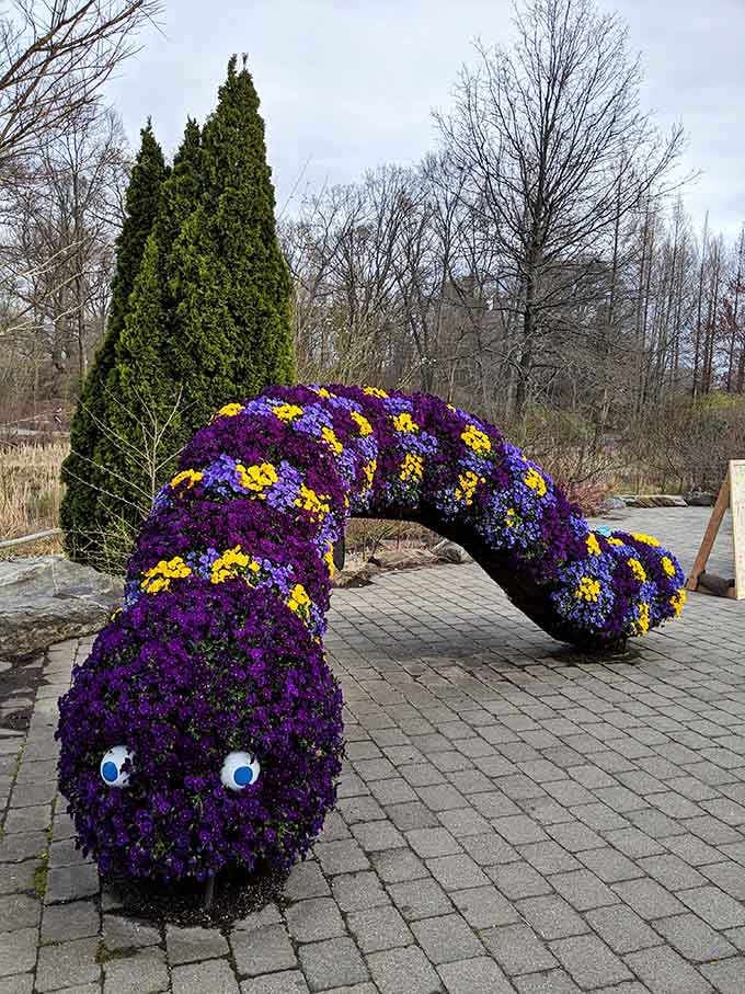 A flower-covered caterpillar sculpture so cheerful it makes you smile despite yourself, guaranteed.
