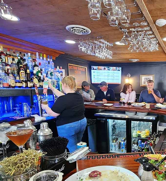 The bar area gleams with possibility, where skilled bartenders craft drinks as memorable as the food itself.